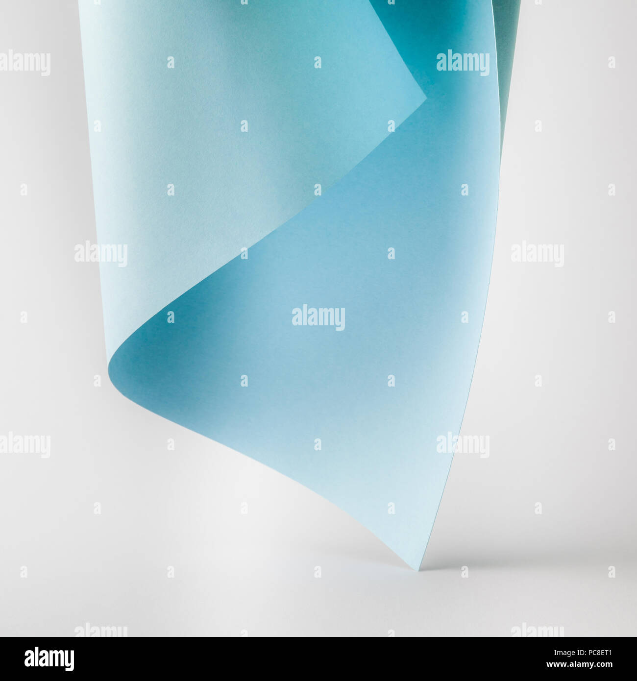 close-up view of tender blue paper sheet on grey background Stock Photo ...