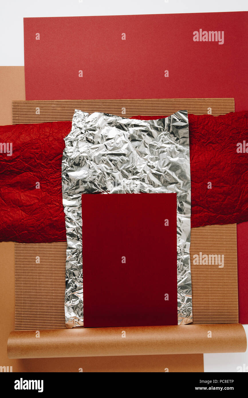 close-up view of various paper, foil and cardboard textures on grey ...