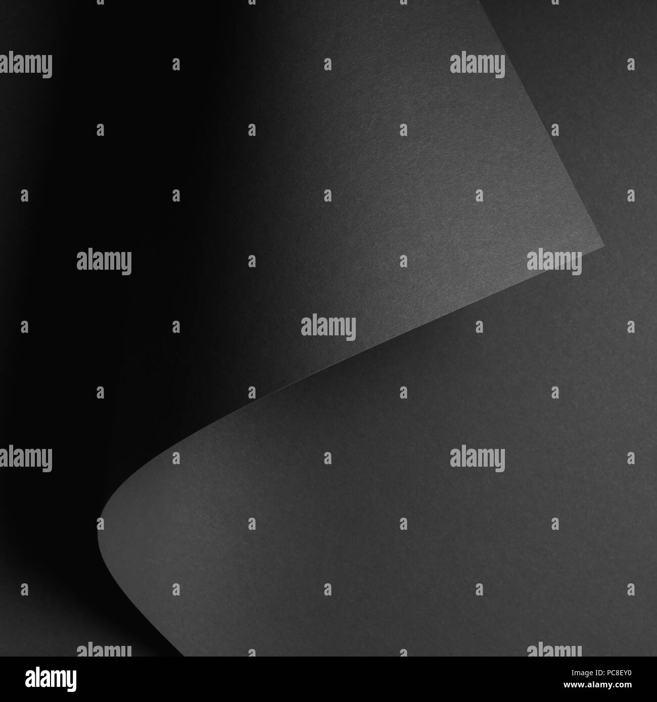 dark abstract background with black rolled paper sheet Stock Photo - Alamy