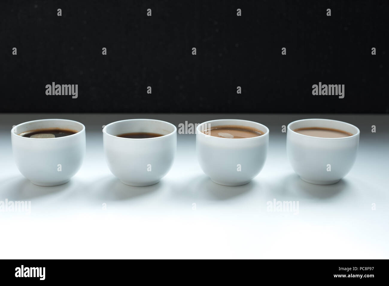 different kinds of coffee in row on white table, close-up view Stock ...