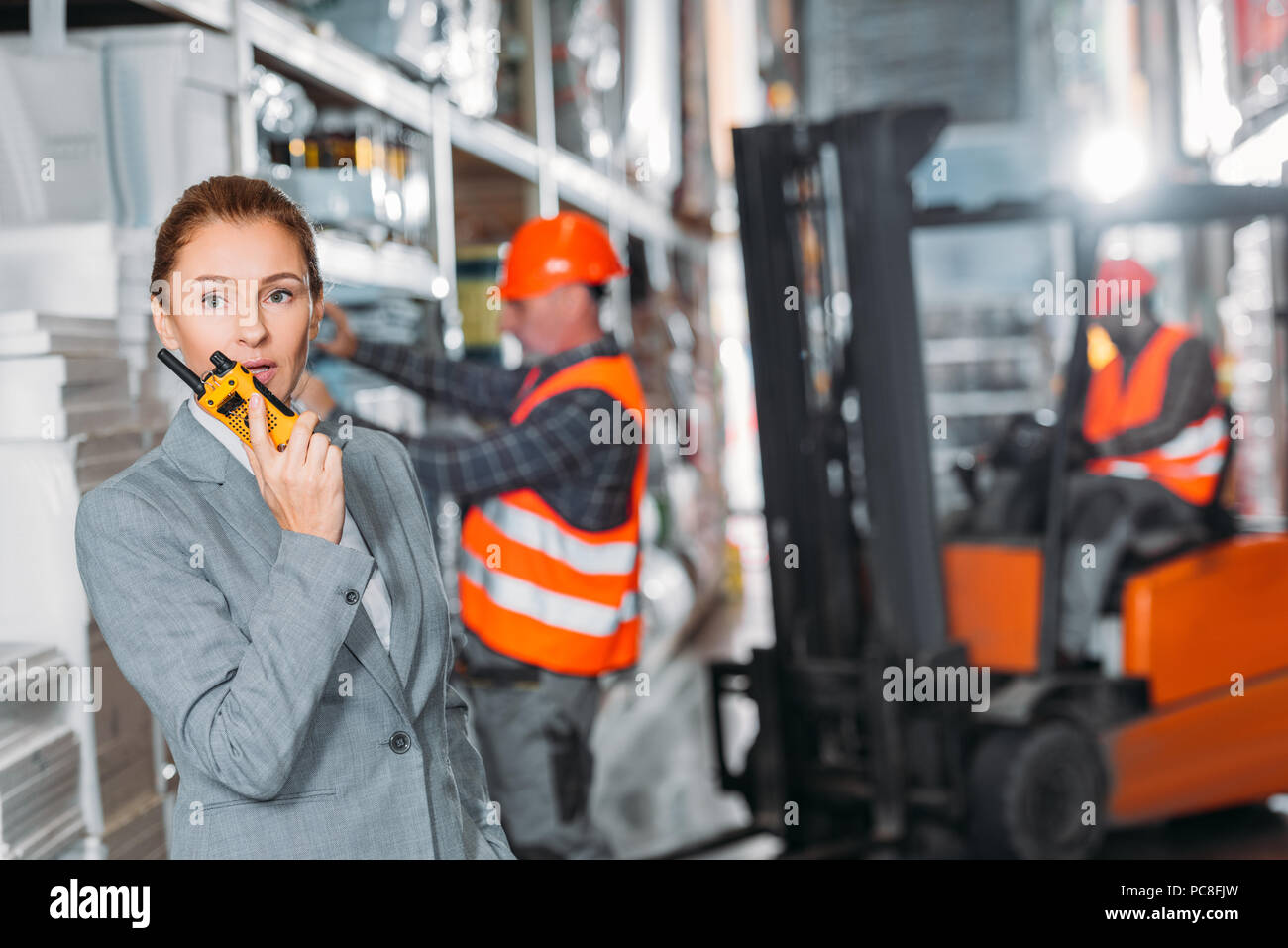 female inspector with walkie talkie in shipping stock Stock Photo - Alamy
