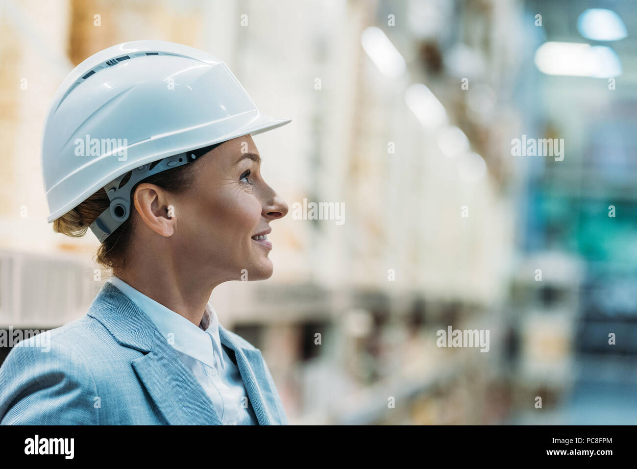 female inspector in white helmet in warehouse Stock Photo - Alamy