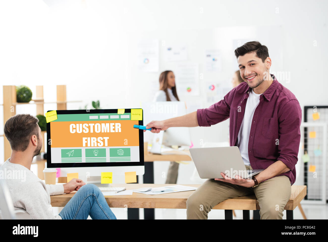 businessman pointing at customer first inscription on computer screen ...