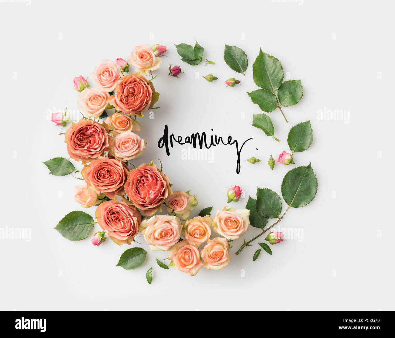 DREAMING sign inside pink flower wreath with leaves, buds and petals ...