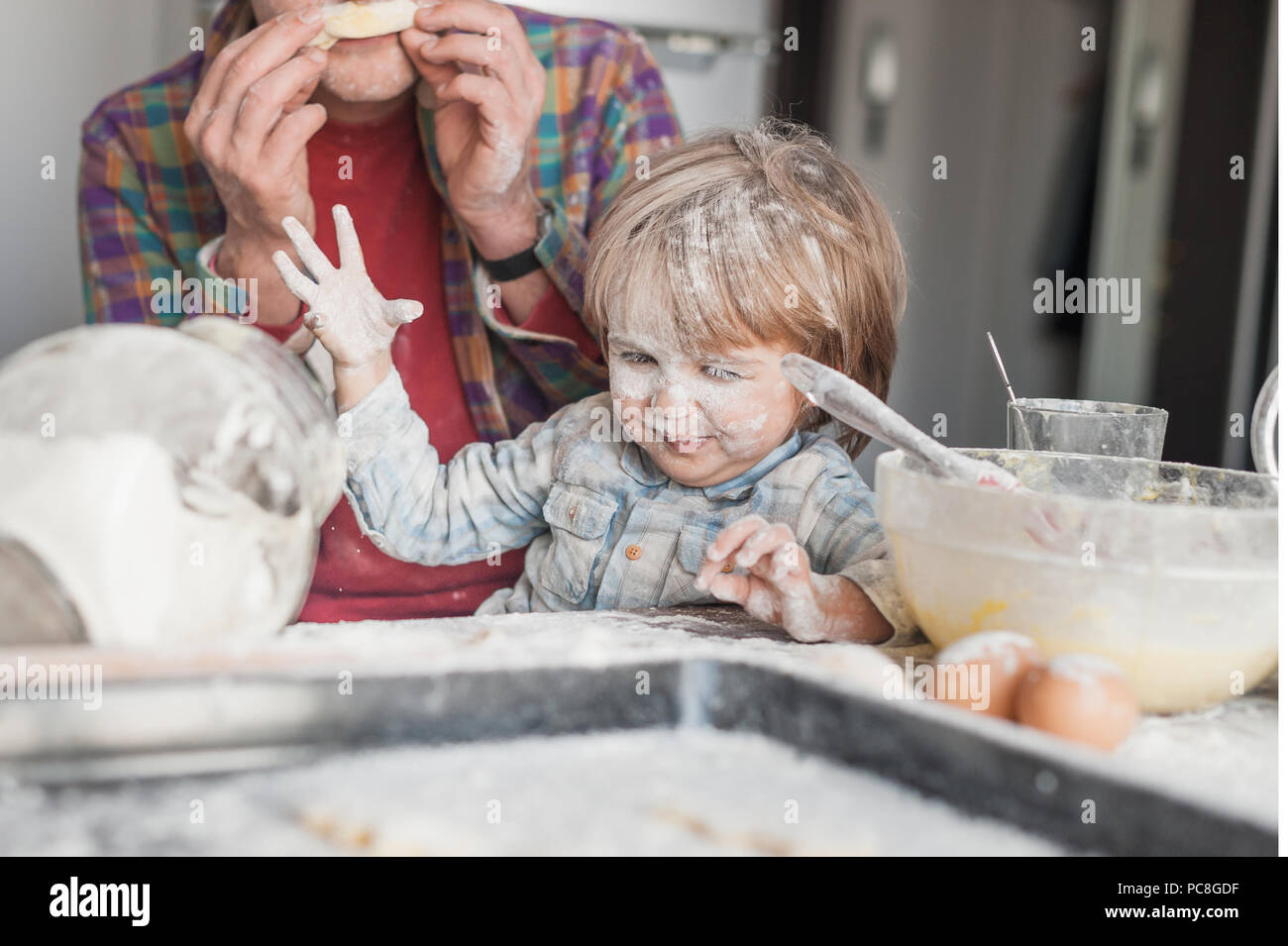 father and child having fun with flour at kitchen Stock Photo - Alamy
