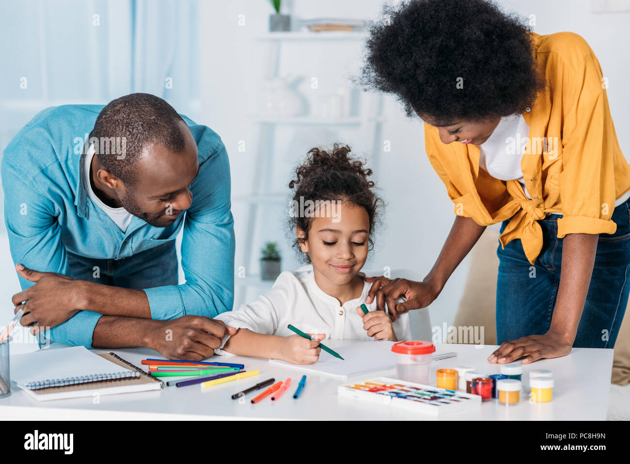 Woman helping daughter drawing hi-res stock photography and images - Alamy