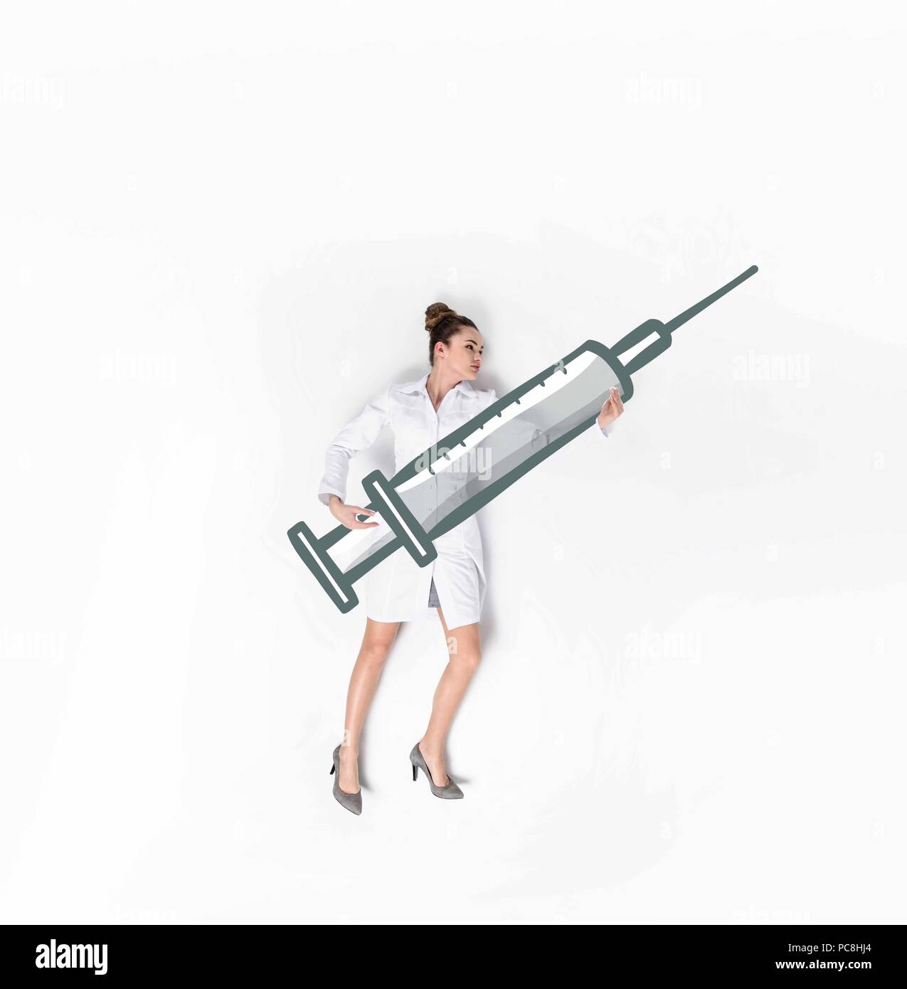 creative collage of young female doctor holding hand-drawn syringe ...