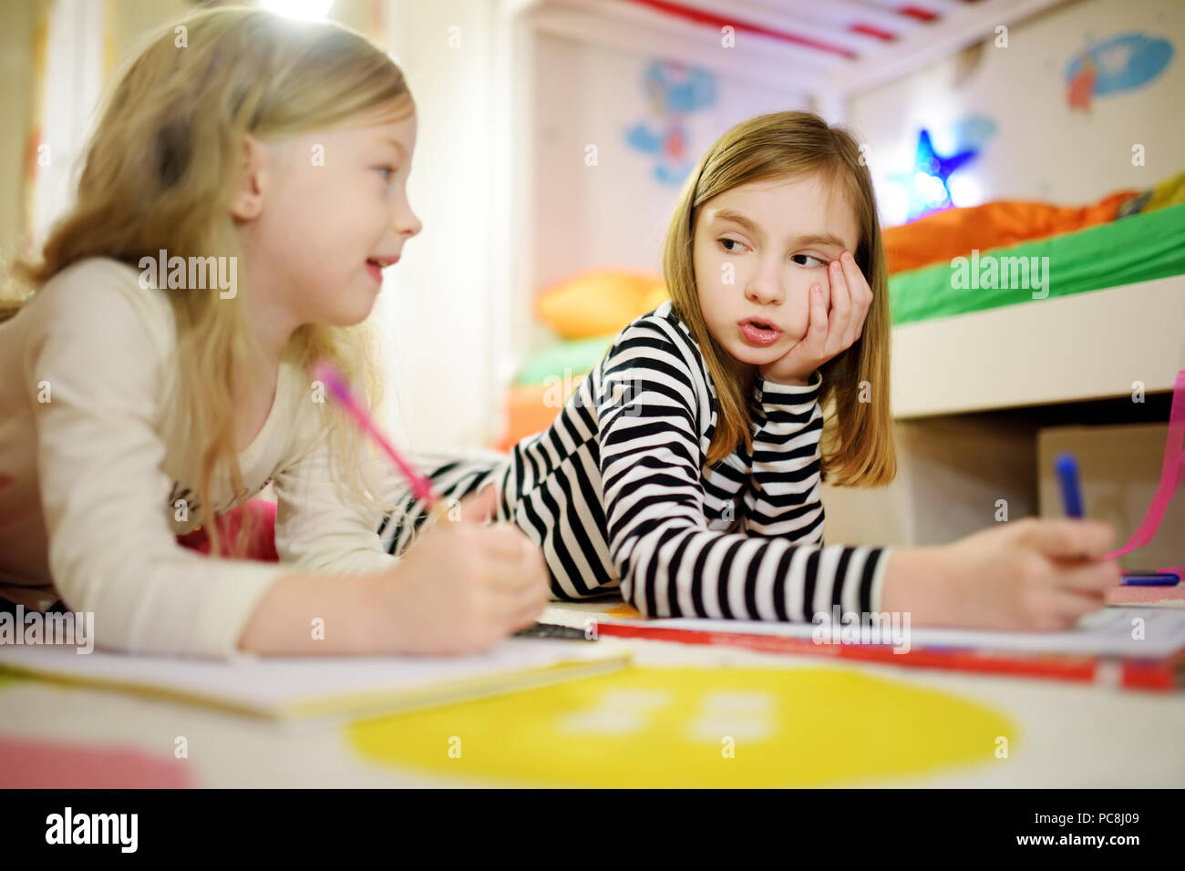 Sister helping younger sister homework hi-res stock photography and ...