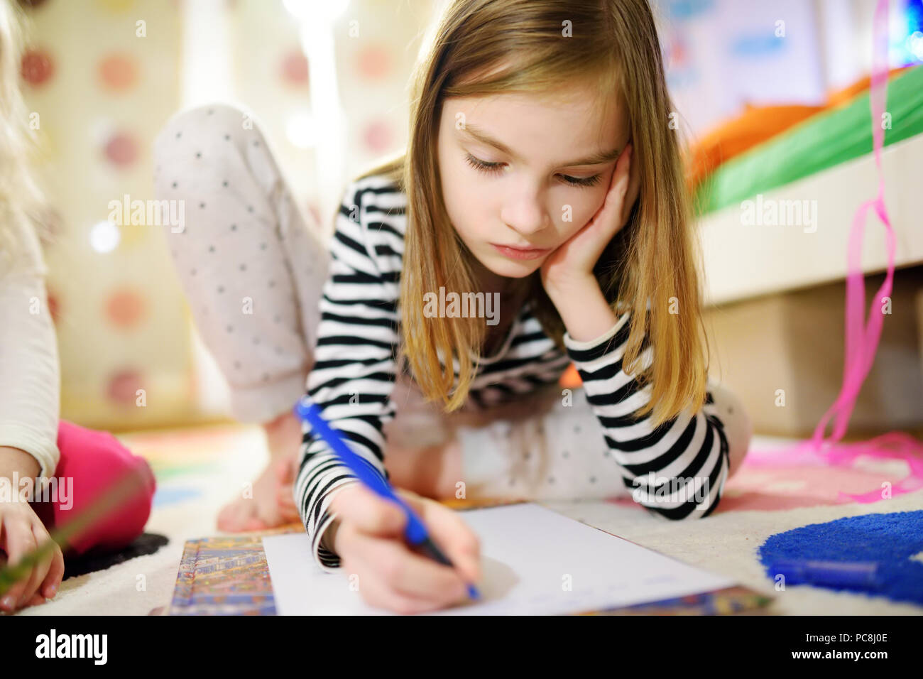 Sister helping younger sister homework hi-res stock photography and ...