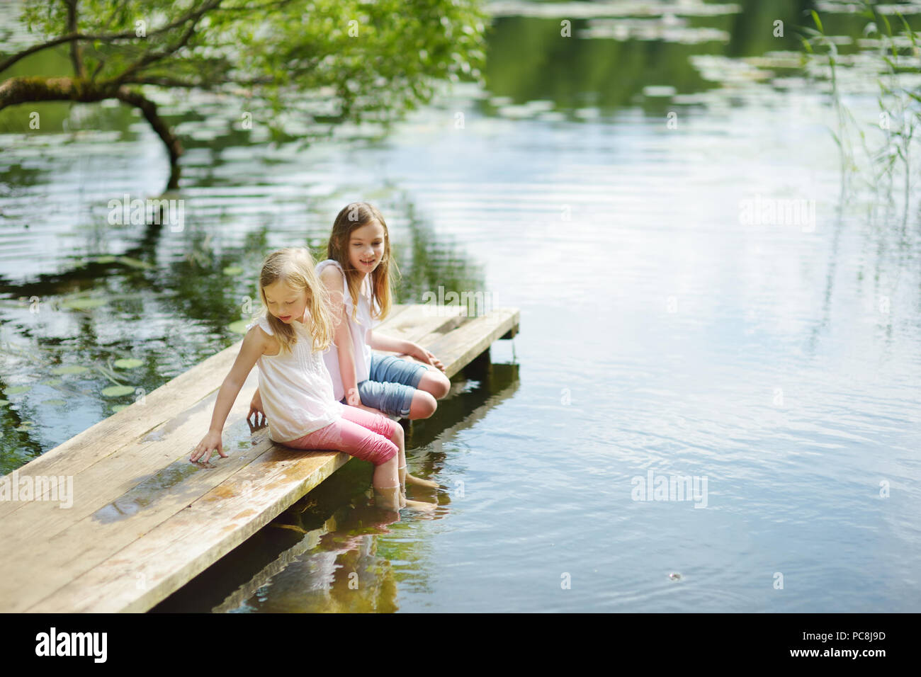 Girl dipping feet lake hi-res stock photography and images - Alamy