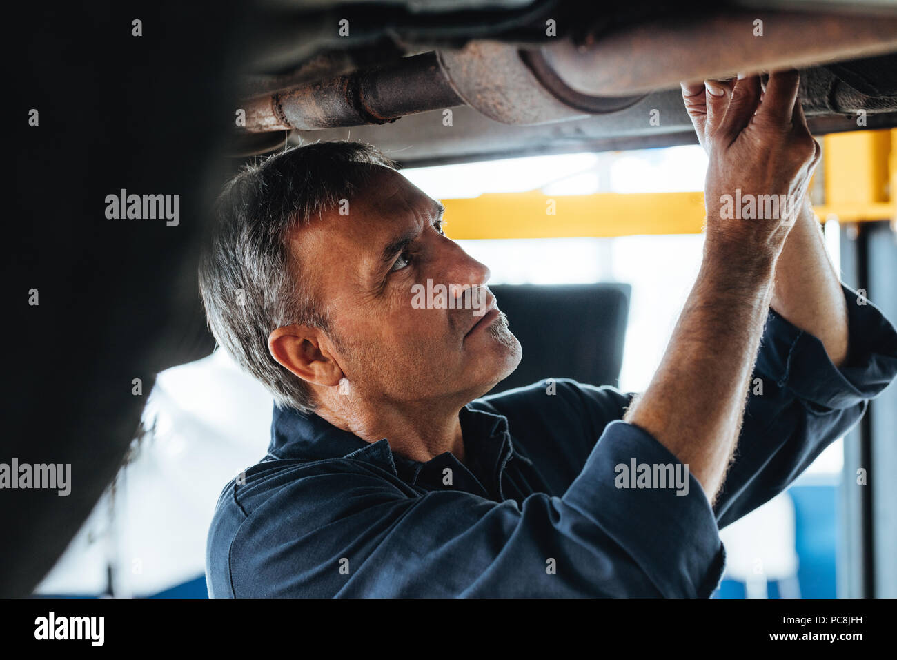 Car mechanic working in repair garage hi-res stock photography and ...