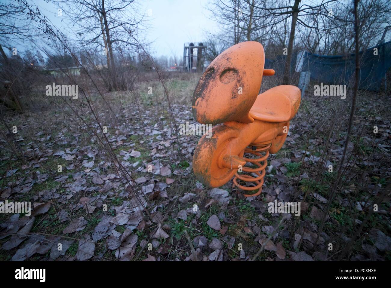 Abandoned play park for children with an old springer toy (eerie and ...