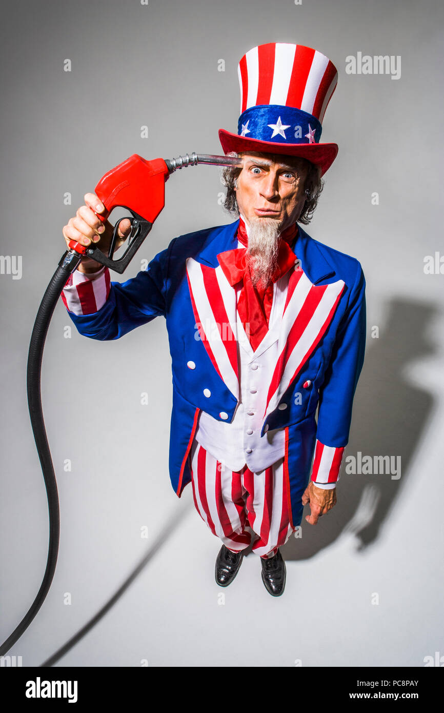 Uncle Sam standing with a gas pump nozzel held in front of him ...