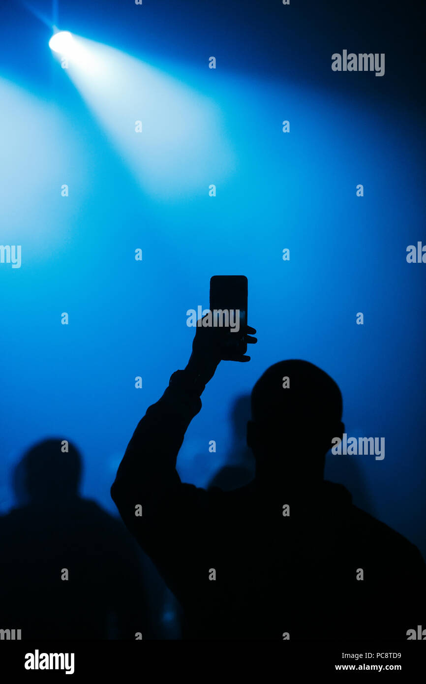 Music fan filming concert with smart phone camera Stock Photo - Alamy
