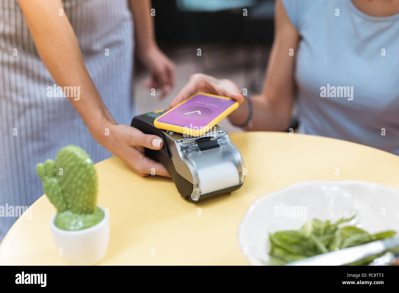 Receiving payment. Professional waitress receiving payment from her ...