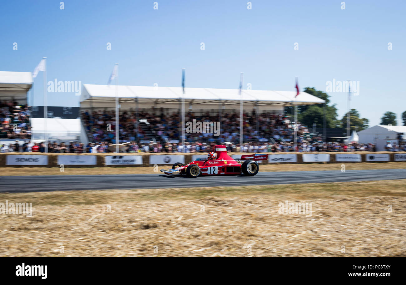 A Ferrari Formula One car speeds past a grandstand on the hillclimb at ...