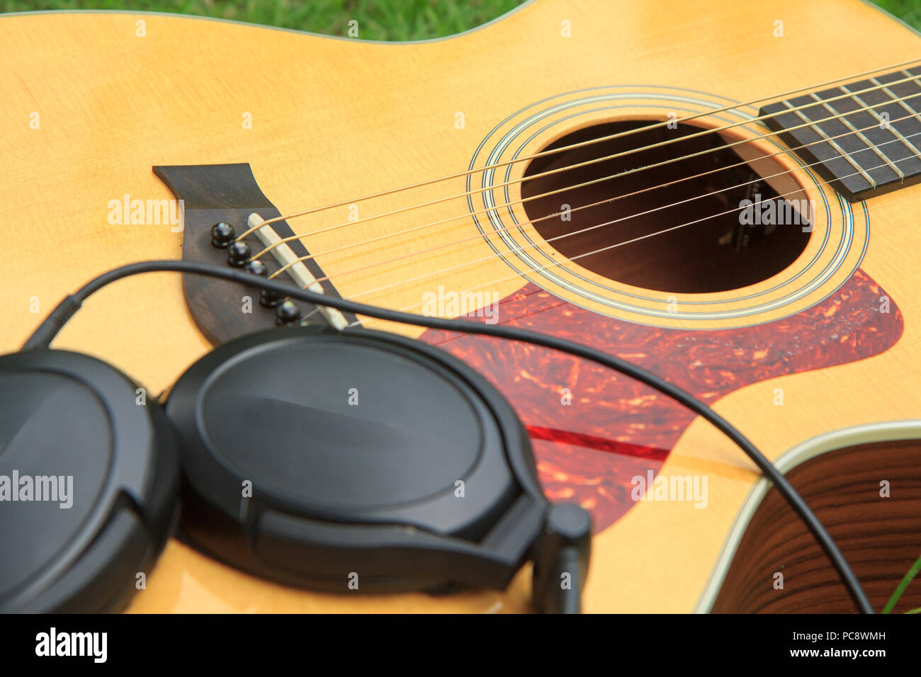 acoustic guitar on the green grass Stock Photo - Alamy