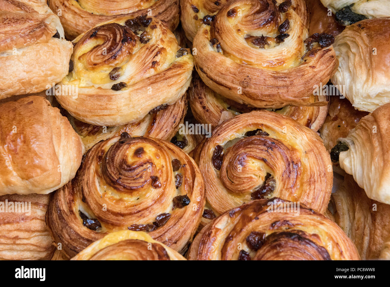 pan au raisin pastries on an artisan bakers stall at a marketplace ...