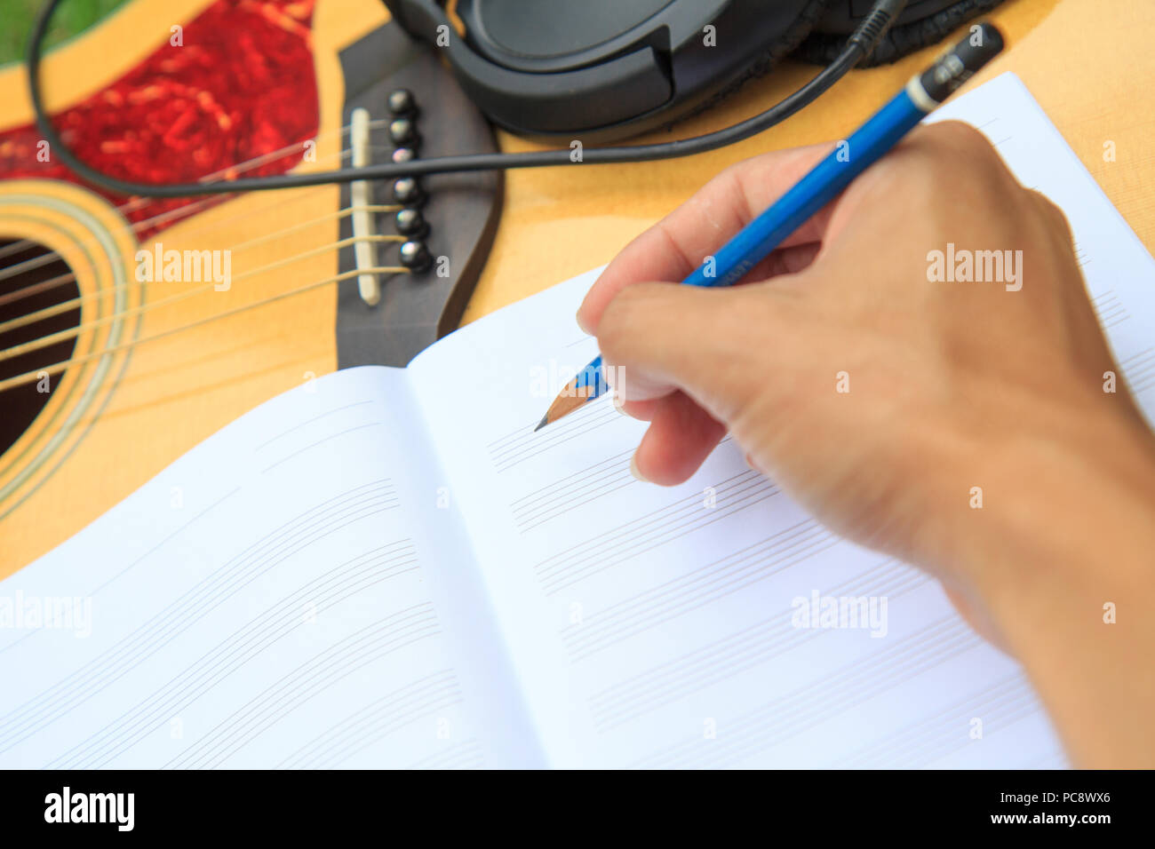 composer write note of song and use acoustic guitar for play Stock ...