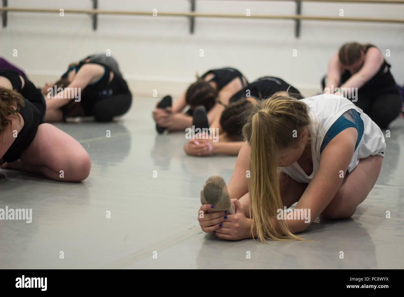 Young dancers stretching during rehearsal Stock Photo - Alamy