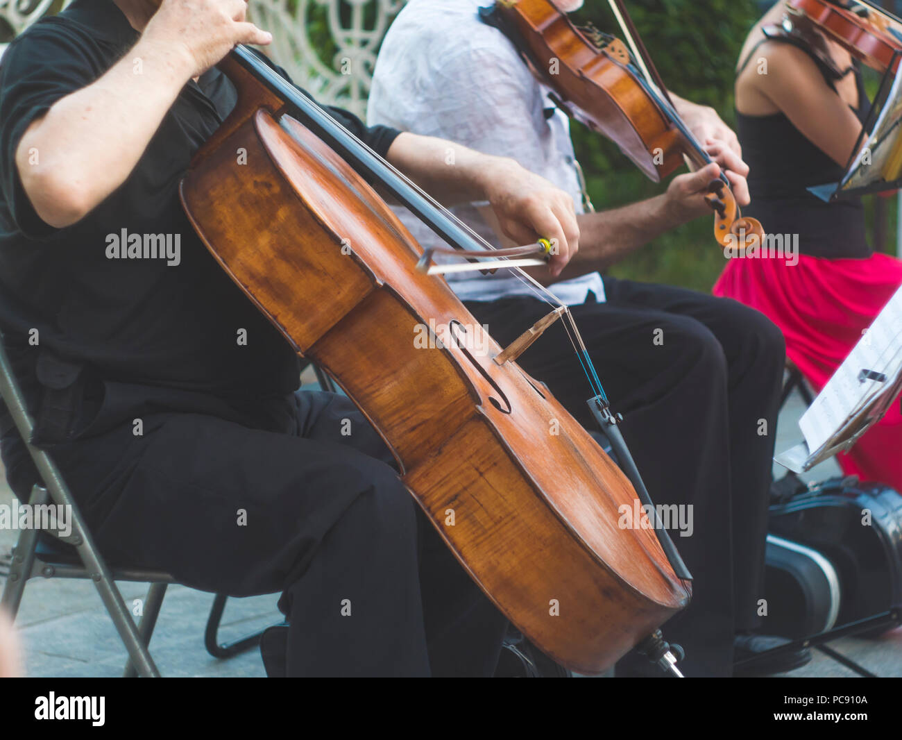 Person playing the cello in the street hi-res stock photography and ...