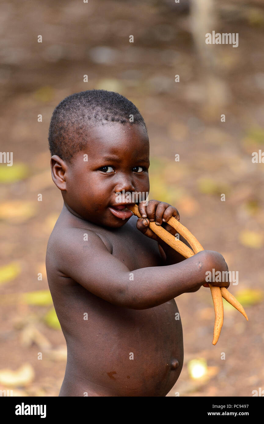 DANKOLI, BENIN - JAN 12, 2017: Unidentified Beninese little boy eats ...