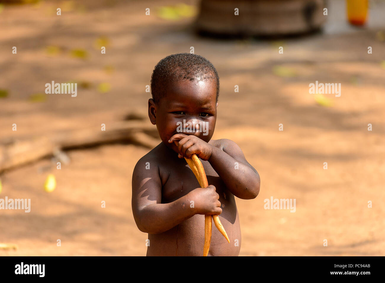 DANKOLI, BENIN - JAN 12, 2017: Unidentified Beninese little boy eats ...