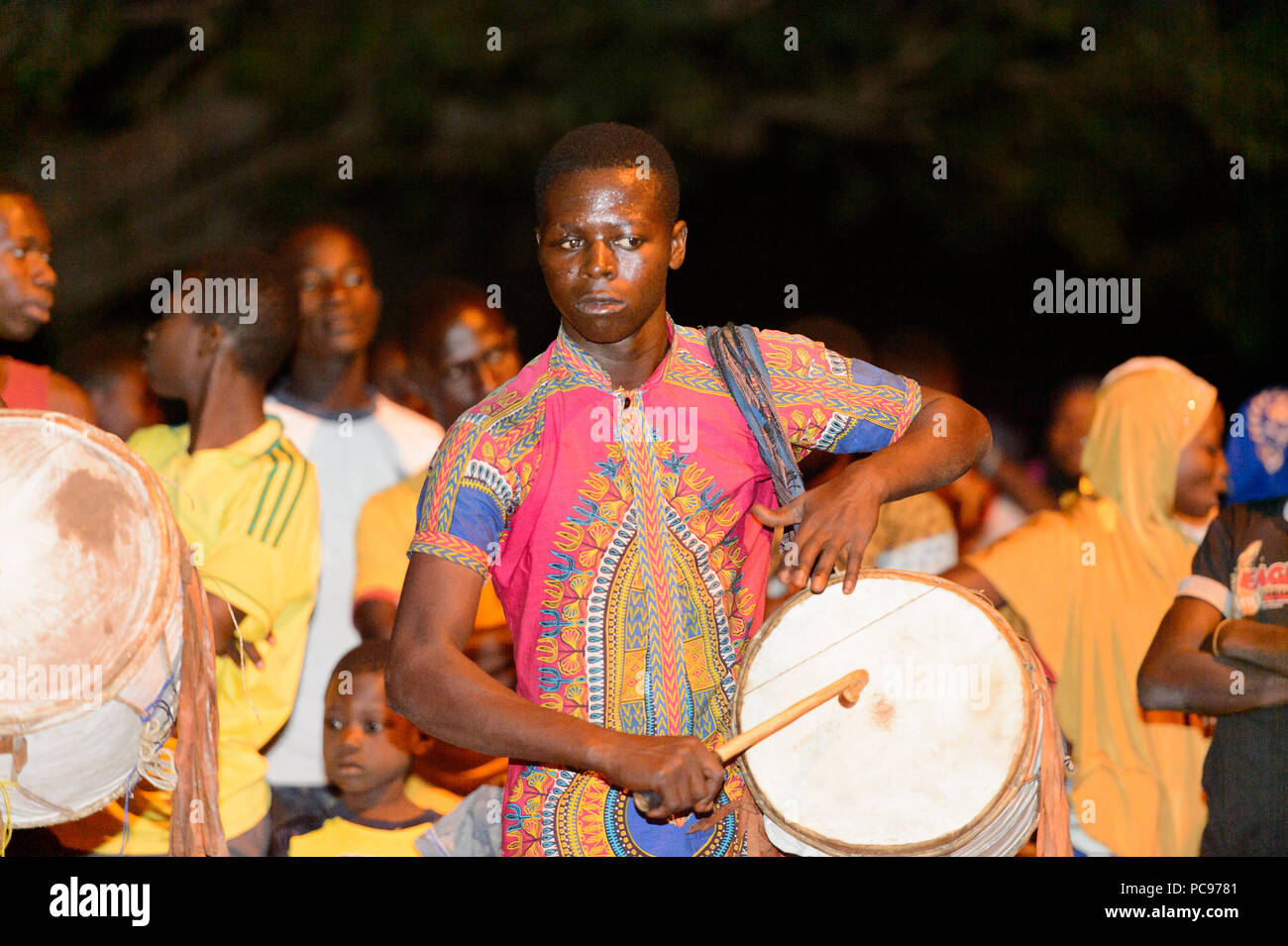 SOKODE, TOGO - JAN 12, 2017: Unidentified Togolese musician hits a drum ...
