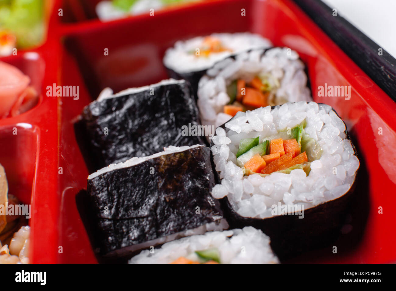 Fresh food portion in japanese bento box with salad, main course. Sushi ...