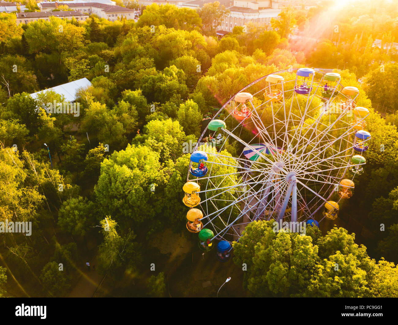 aerial amazing magic view of ferris wheel during sunset golden hour in ...