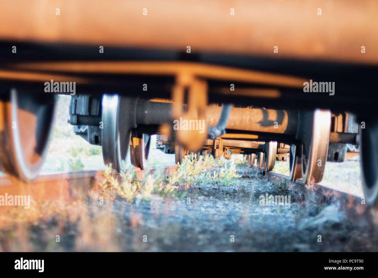 View under the train on wheels and rocky railway Stock Photo - Alamy