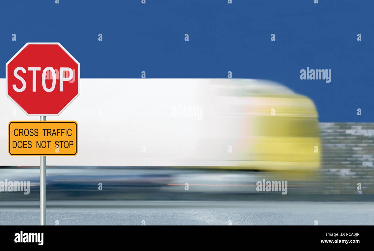 Red stop road sign, motion blurred truck vehicle traffic background ...