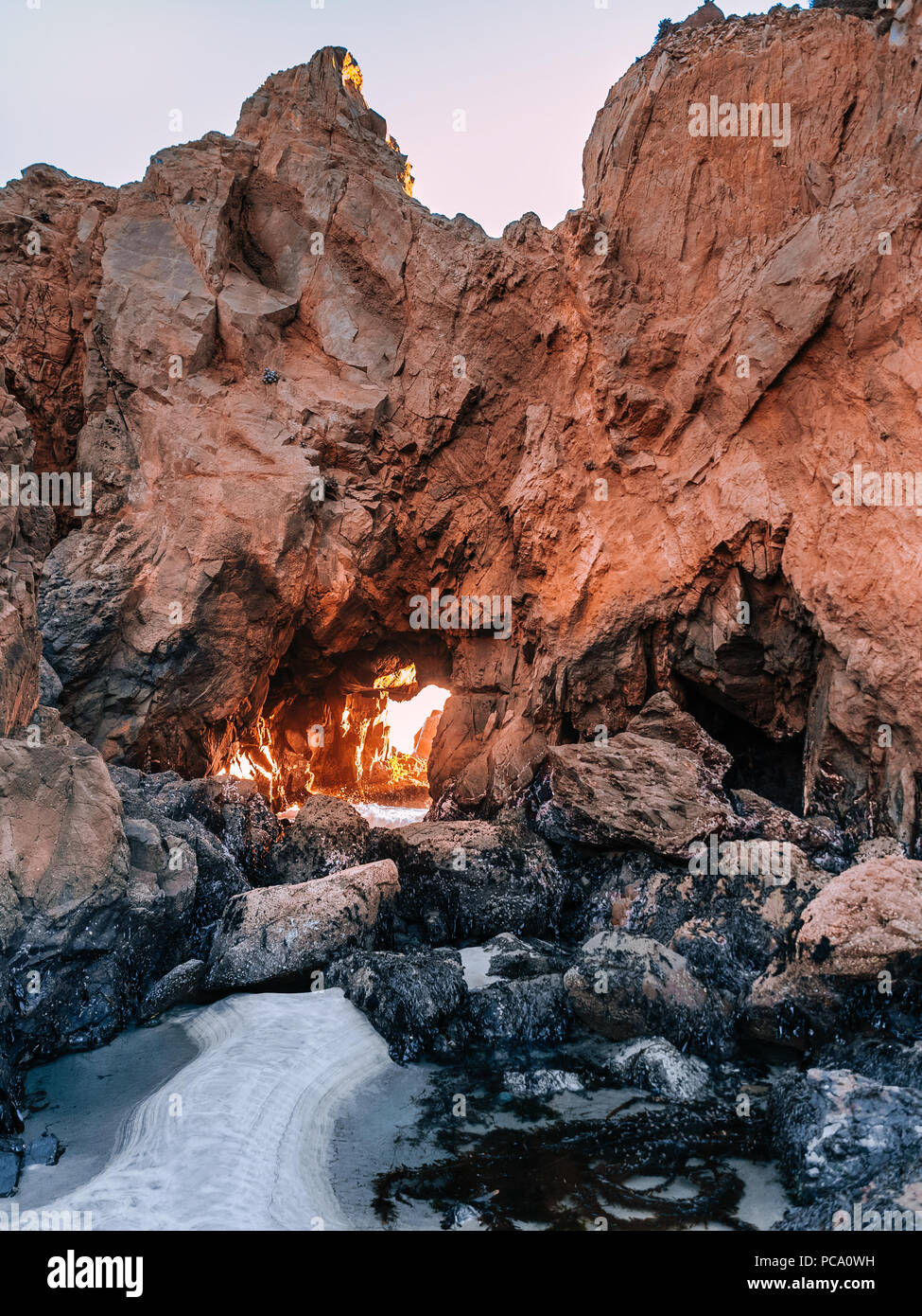 Vertical shot of the famous cliff with Keyhole Arch at Pfeiffer Big Sur ...