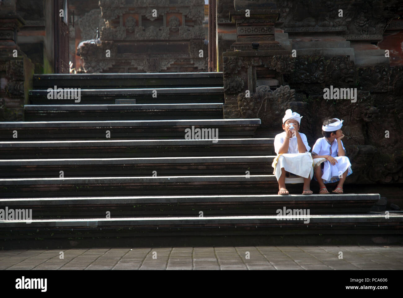 Waiting for a Hindu temple procession to arrive, boys on the temple ...