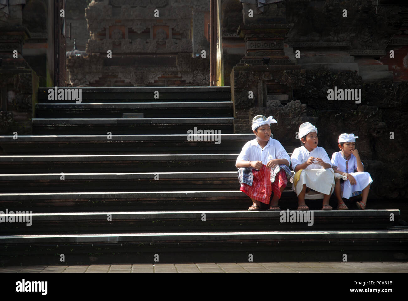 Waiting for a Hindu temple procession to arrive, boys on the temple ...