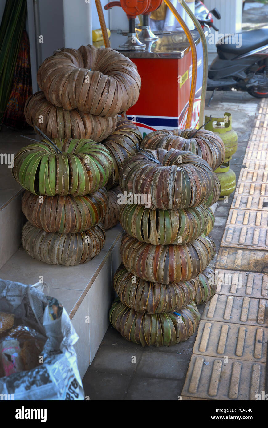 Piles of woven doughnut shaped bundles of bamboo, Ubud, Bali, Indonesia ...