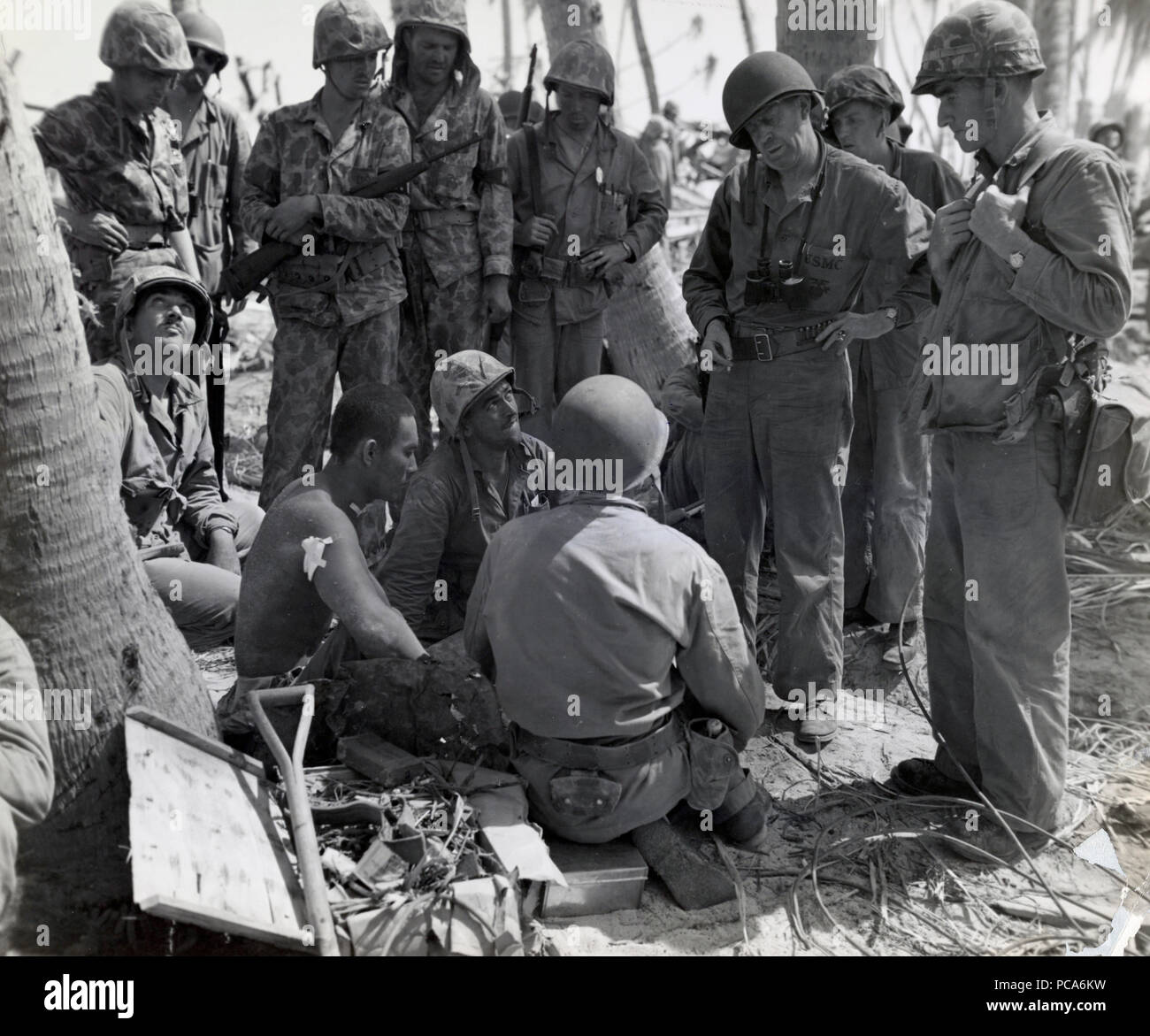 World War II Photo - wounded Japanese prisoner with group of marine ...