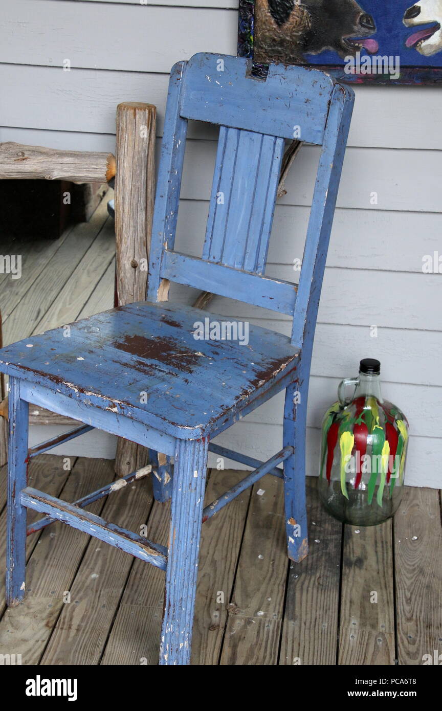 The blue antique chair has a lot of character Stock Photo - Alamy