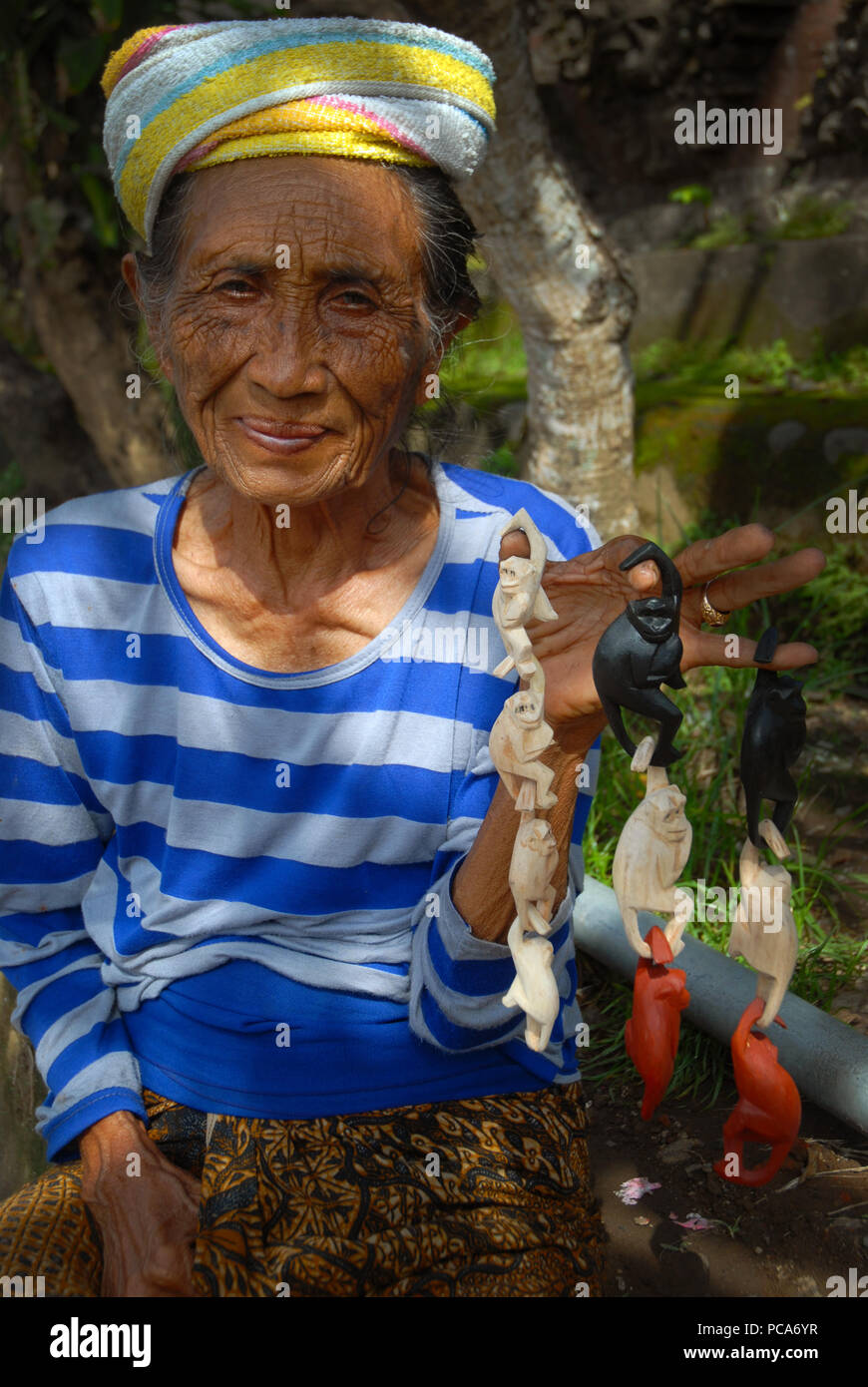 Old lady selling carved monkeys for tourists, Ubud, Bali. Indonesia ...