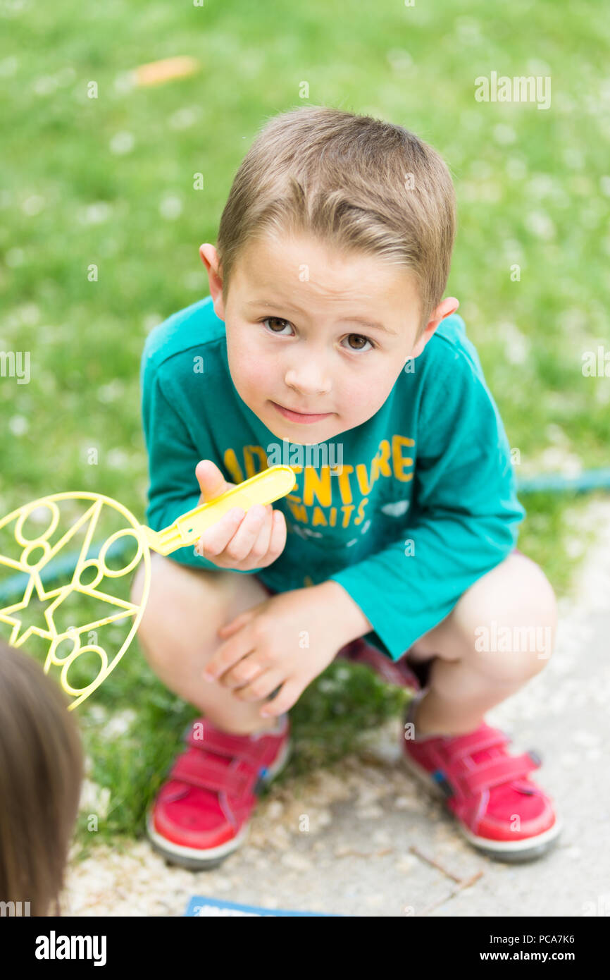 Boy squatting hi-res stock photography and images - Alamy