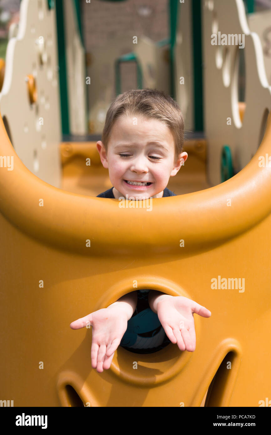 Little boy sticking hands through play structure hole, open palm Stock ...