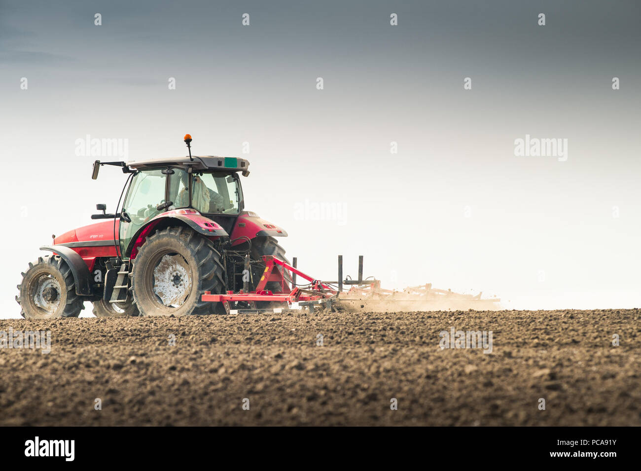 Tractor preparing land for sowing Stock Photo - Alamy