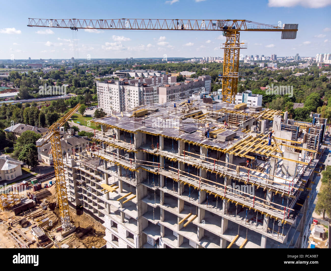 aerial view of the apartment building under construction with cranes ...