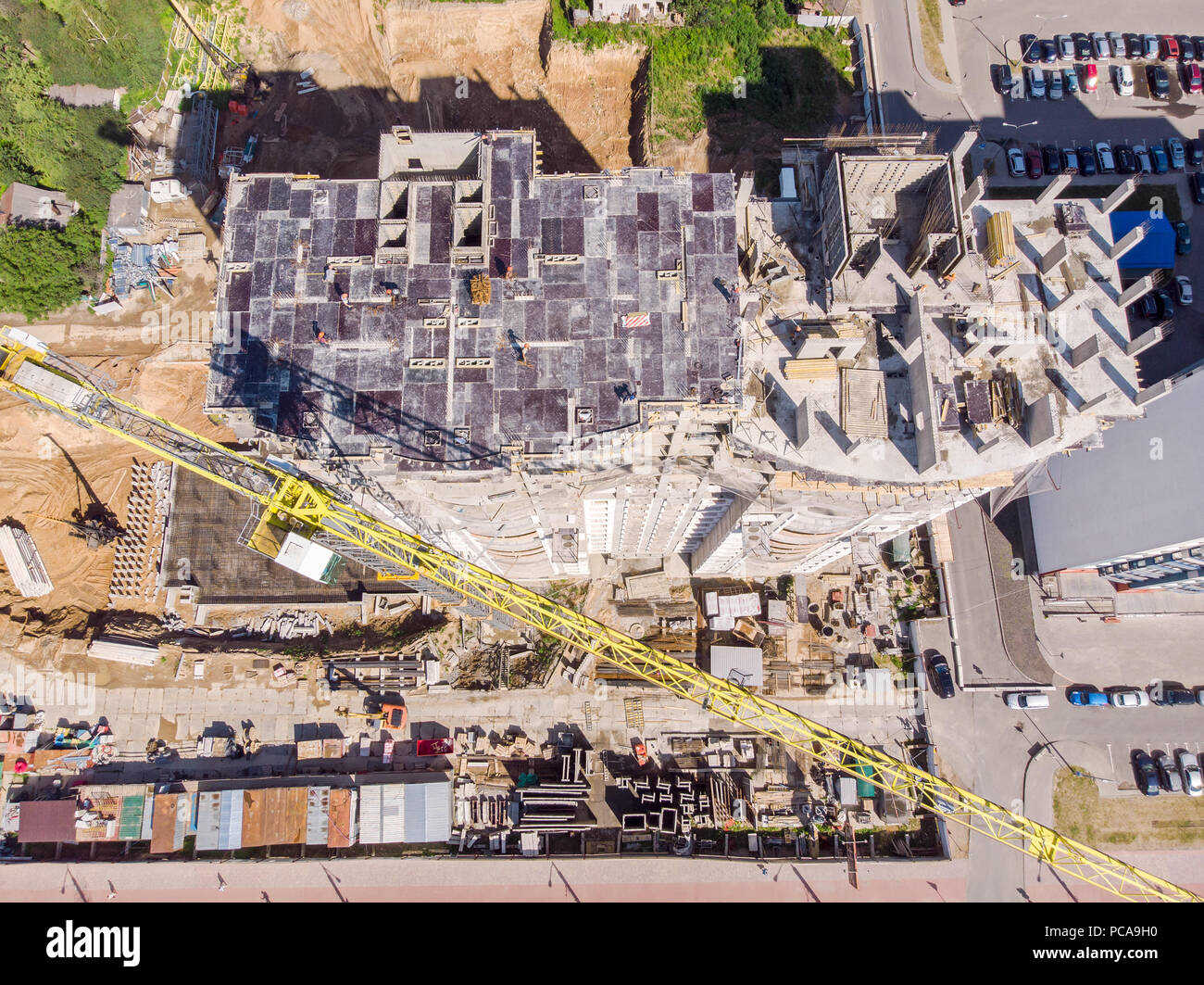 drone photo of new building under construction with tower cranes ...