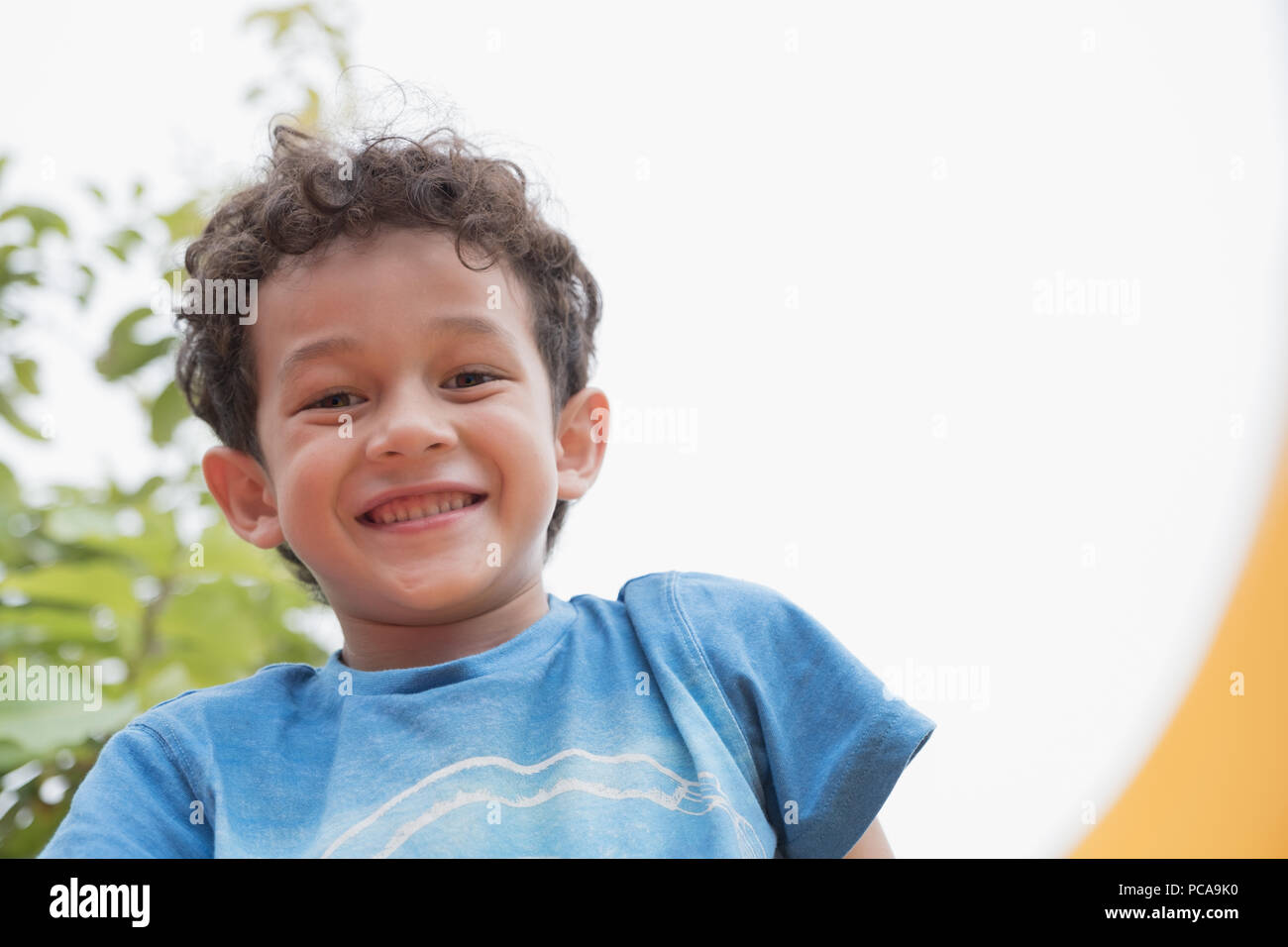 kid boy having fun to play on children's climbing toy at school ...