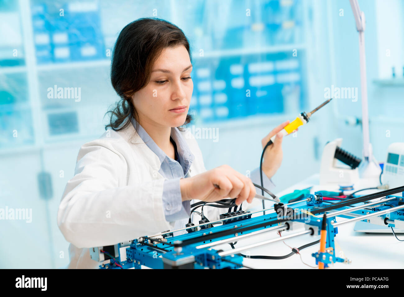 Student girl in electronics laboratory, experiment with microcontroller ...