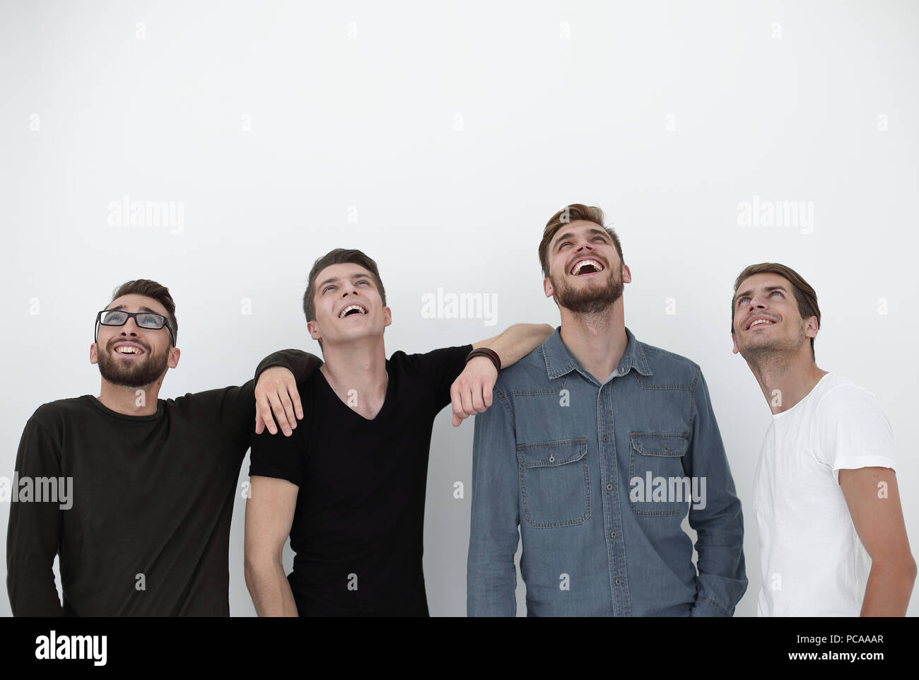 Happy positive group of men looking up with dreamy expression Stock ...