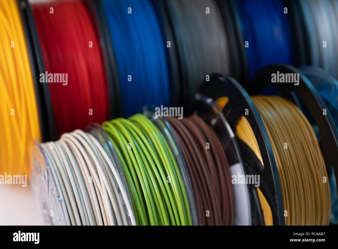 ABS and PLA filament next to 3D Printer. Plastic coils Stock Photo - Alamy