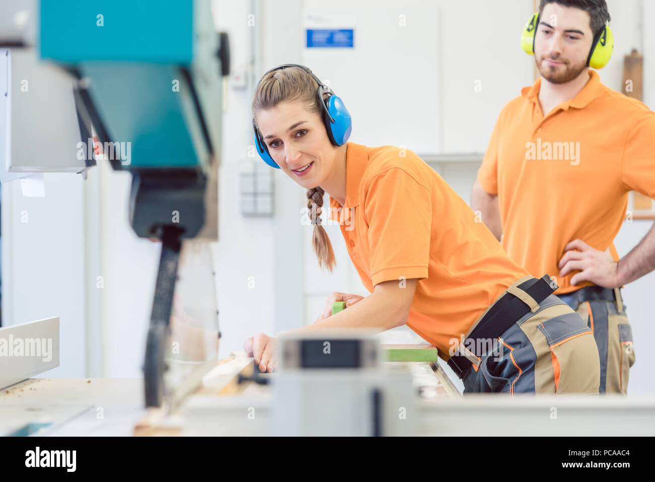 Carpenter watching his apprentice working Stock Photo - Alamy