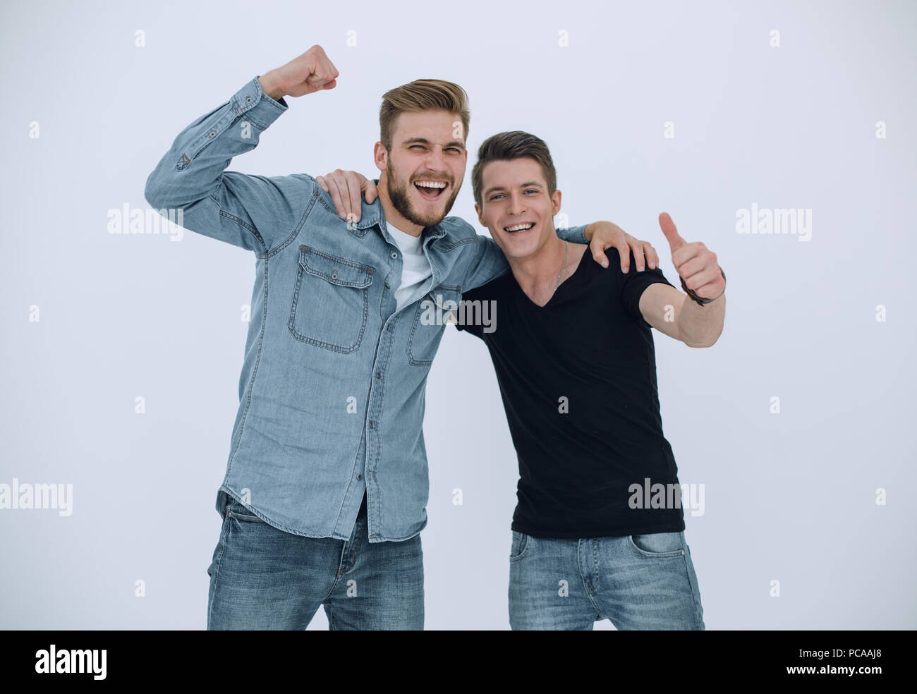 Portrait of two young people celebrating on a white background Stock ...